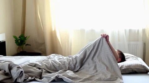 child lying on the bed in the bedroom an... | Stock Video | Pond5
