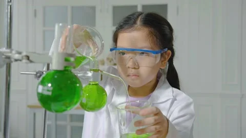 Child mixing chemical ingredients one by... | Stock Video | Pond5