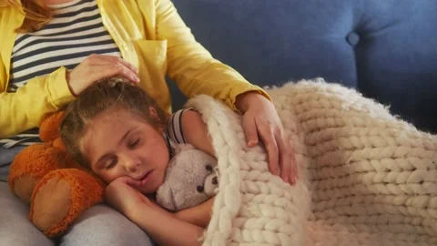 child. mom puts daughter to bed. happy f... | Stock Video | Pond5