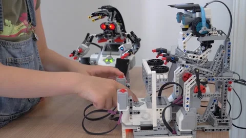 Child is playing with a mini robot DJ | Stock Video | Pond5