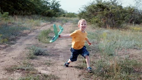 Child playing outdoors on nature. Kid bo... | Stock Video | Pond5