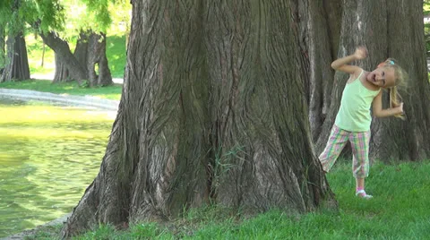 Child Playing Peak a Boo in Park, Girl H... | Stock Video | Pond5