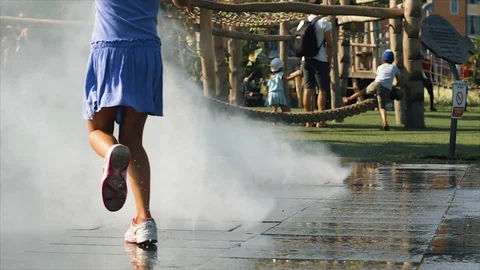Child plays in steam escaping from paver... | Stock Video | Pond5
