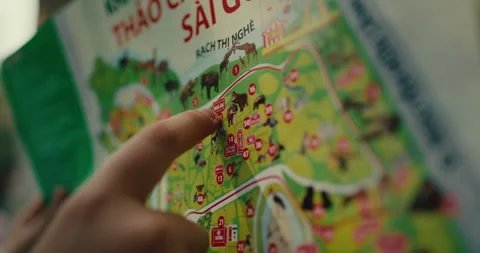 Child pointing at zoo map outdoors, show... | Stock Video | Pond5