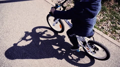 Child riding bicycle. Top view perspecti... | Stock Video | Pond5