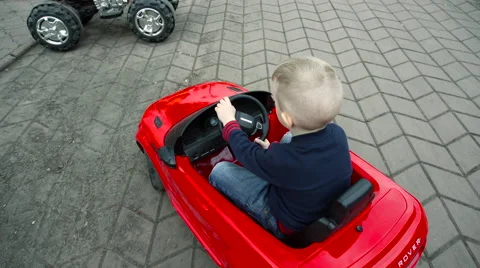 Child Riding on a Toy Car | Stock Video | Pond5
