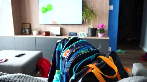 Child school backpack laying on a sofa i... | Stock Video | Pond5