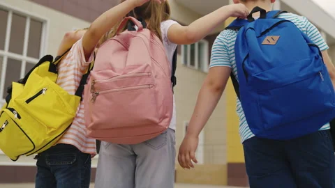 child schoolchildren with backpacks hug ... | Stock Video | Pond5