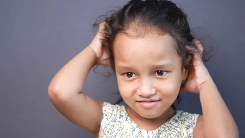 child Scratching Head Against black back... | Stock Video | Pond5