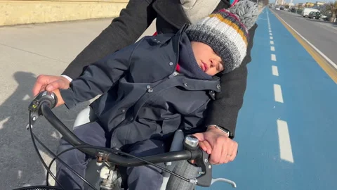 Child sleeping while riding bicycle with... | Stock Video | Pond5