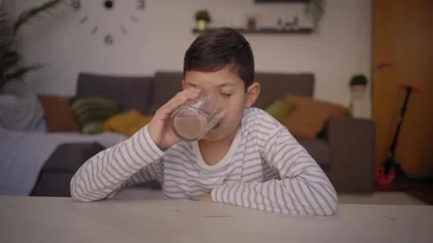 Child snacking on chocolate milkshake. B... | Stock Video | Pond5