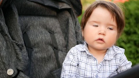 the child stares intently. sitting in hi... | Stock Video | Pond5