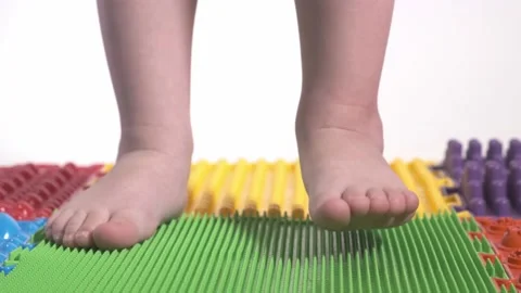 A child stomps on an orthopedic mat. foo... | Stock Video | Pond5