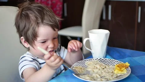 The child at the table eating hot food. ... | Stock Video | Pond5