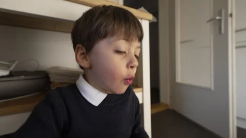 Child taking a bite of bread with cheese... | Stock Video | Pond5
