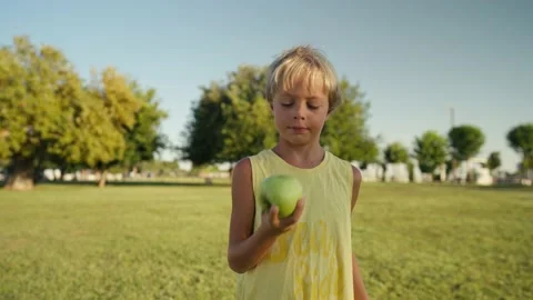 Child throwing up an apple. Healthy Life... | Stock Video | Pond5