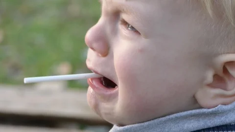 A child of two years is crying with cand... | Stock Video | Pond5