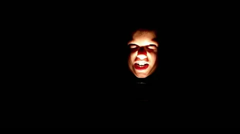 Child using flashlight on face in dark r... | Stock Video | Pond5