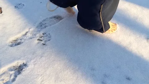 child walking barefoot in snow. Close-up... | Stock Video | Pond5