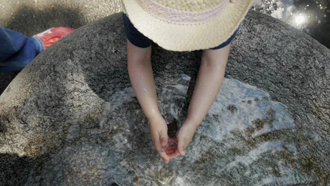Child Washing Hands in Stone Fountain Ba... | Stock Video | Pond5