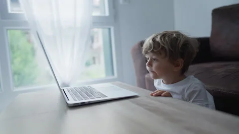 Child watching cartoons on laptop comput... | Stock Video | Pond5