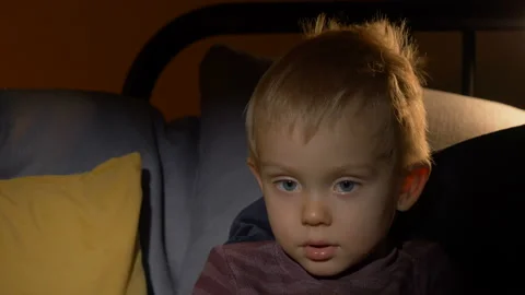Child watching TV in dark bedroom before... | Stock Video | Pond5