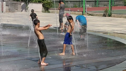 Children cooling off with water in hot w... | Stock Video | Pond5