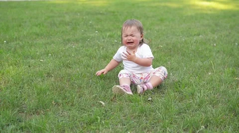 Children crying on green grass backgroun... | Stock Video | Pond5