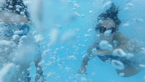 Children dive bombing in summer pool on ... | Stock Video | Pond5