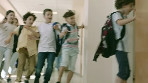 Children entering from school hallway to... | Stock Video | Pond5