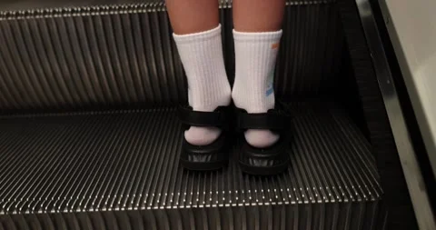 Children feet on metal stairs of escalat... | Stock Video | Pond5