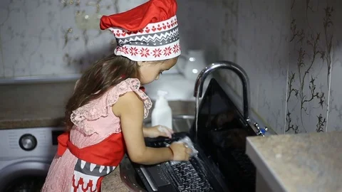 Children girl wash laptop in sink on kit... | Stock Video | Pond5