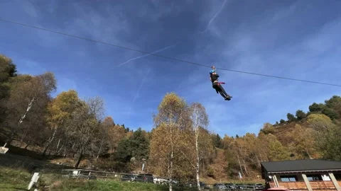Children have fun with zip line at rope ... | Stock Video | Pond5