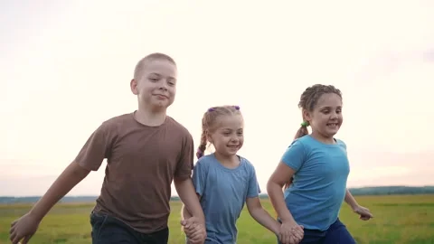 children holding hands running in the pa... | Stock Video | Pond5