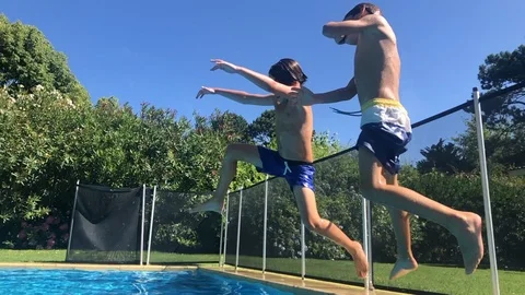 Children jumping inside swimming pool an... | Stock Video | Pond5