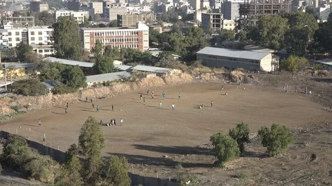 Children play football on dry soccer fie... | Stock Video | Pond5