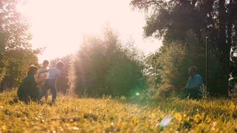 Children playfully run away from father ... | Stock Video | Pond5