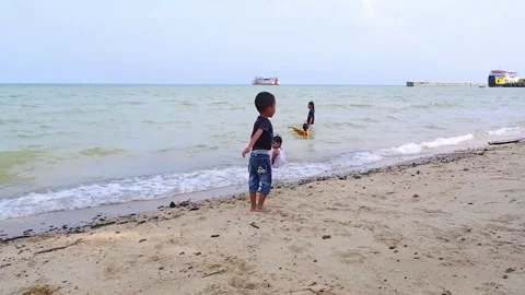 Children Playing And Bathing By The Sea ... | Stock Video | Pond5