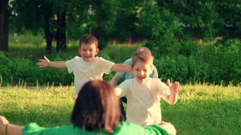 Children playing, running from dad to mo... | Stock Video | Pond5
