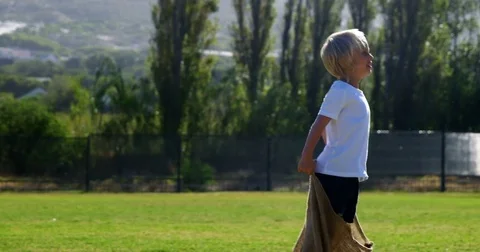 Children playing a sack race in park | Stock Video | Pond5
