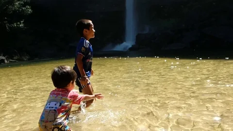 Children playing in waterfall | Stock Video | Pond5
