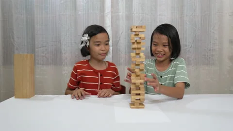 Children playing wood block building gam... | Stock Video | Pond5