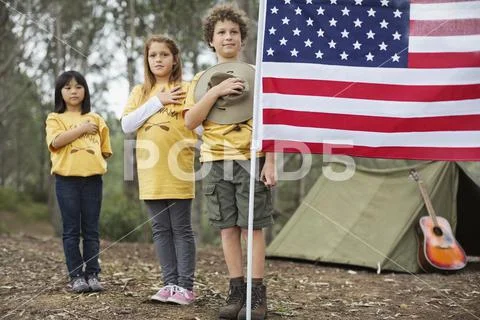 Children reciting pledge of allegiance while camping in forest Stock ...