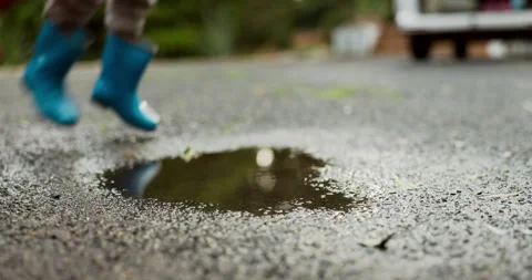 Children, road and jumping in puddle on ... | Stock Video | Pond5