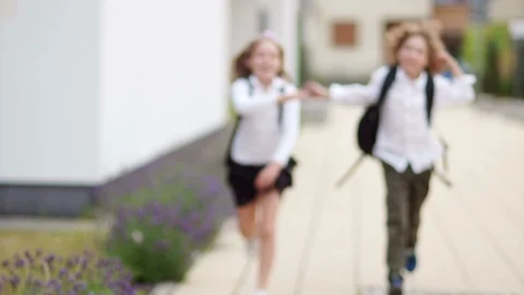 Children run forward from school and wav... | Stock Video | Pond5
