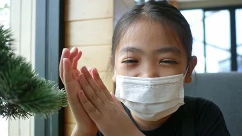 Children shows step for wearing a mask a... | Stock Video | Pond5