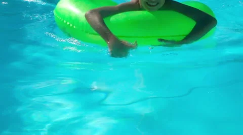 Children sitting on inflatable ring in s... | Stock Video | Pond5