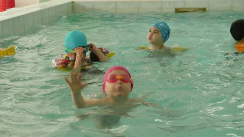 Children swim in the pool. Kids in float... | Stock Video | Pond5