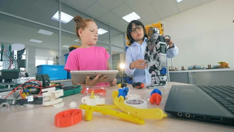 Children try to make a robot on a table,... | Stock Video | Pond5