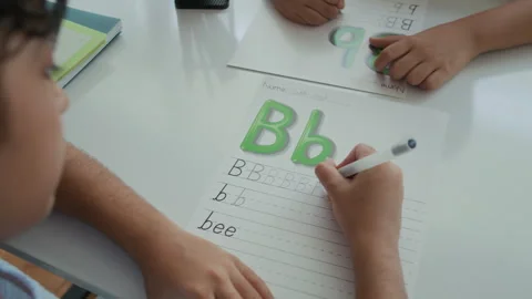 Children Writing Letter B on Worksheet a... | Stock Video | Pond5